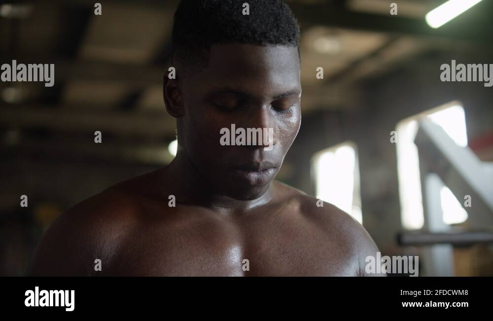 Shirtless African American man breathes deeply with closed eyes in MMA ...