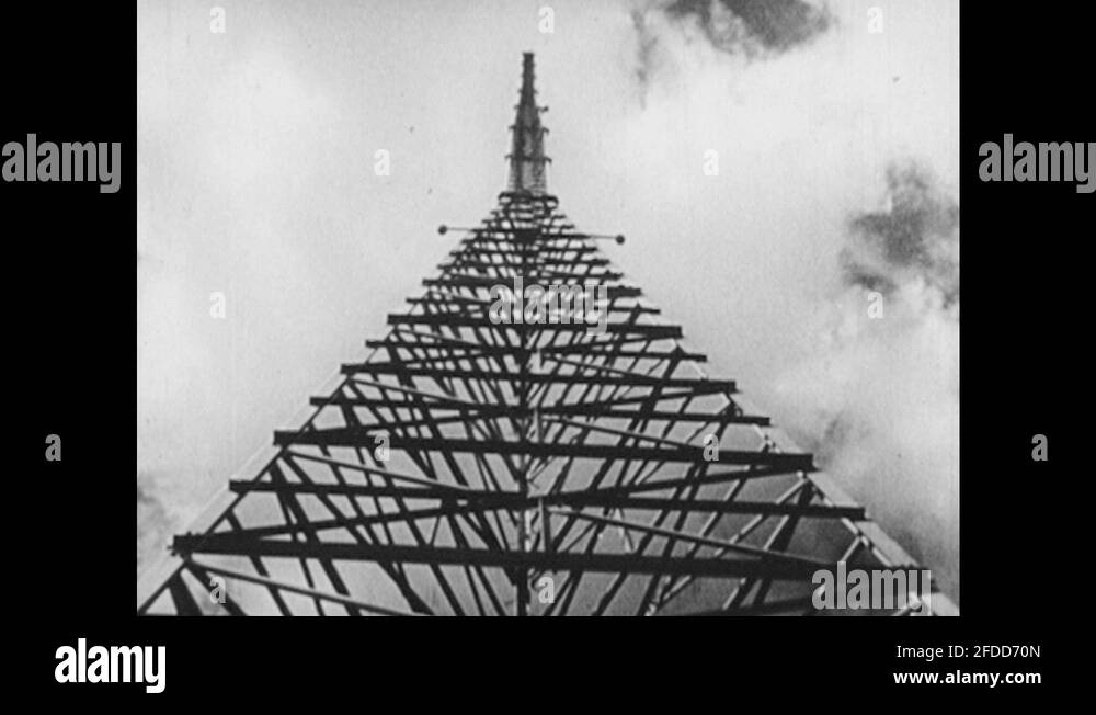 1950s: Electric tower reaching to the sky. Radio in a home's living ...