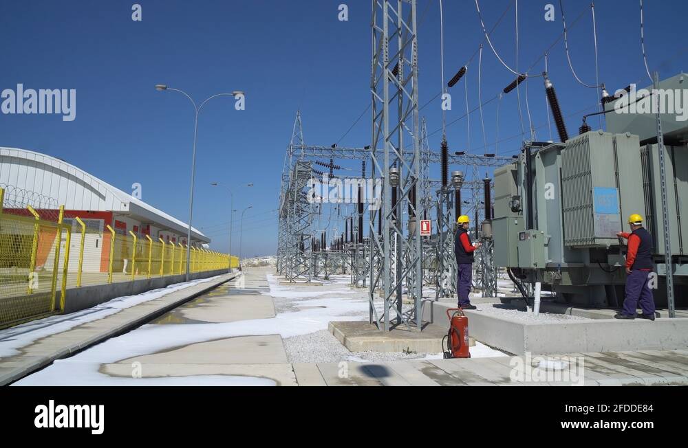 Two workers at the power plant, inspection. Panorama from left to right ...