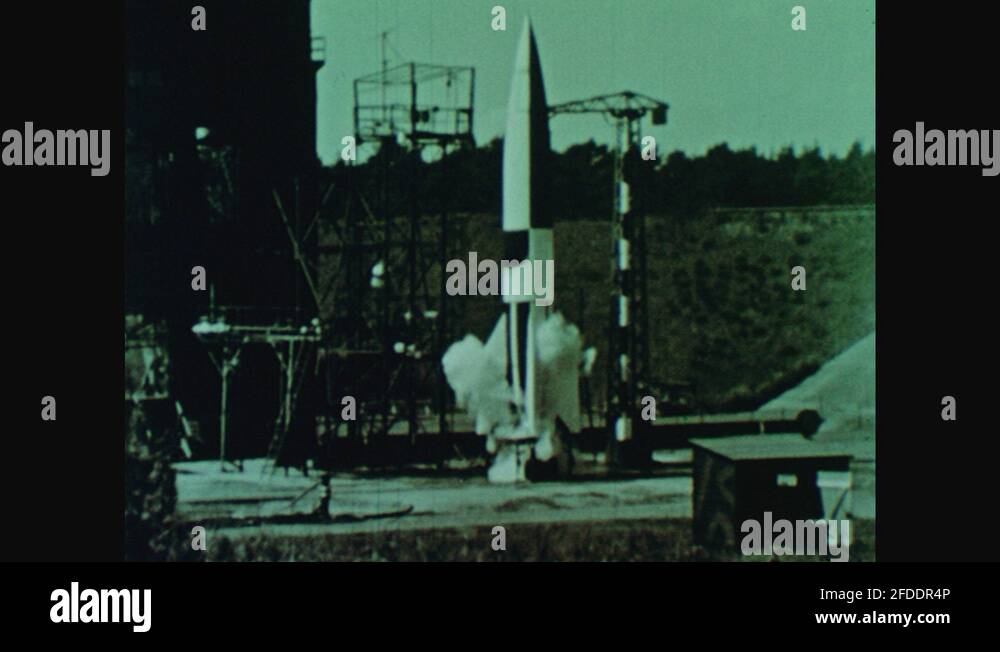 1960s: Rocket launches off of launch pad into sky. Another rocket ...