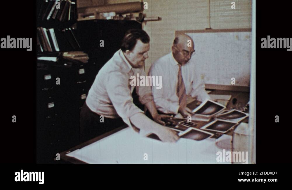 1960s: Scientists sort through 8.5x11 black and white prints of ...