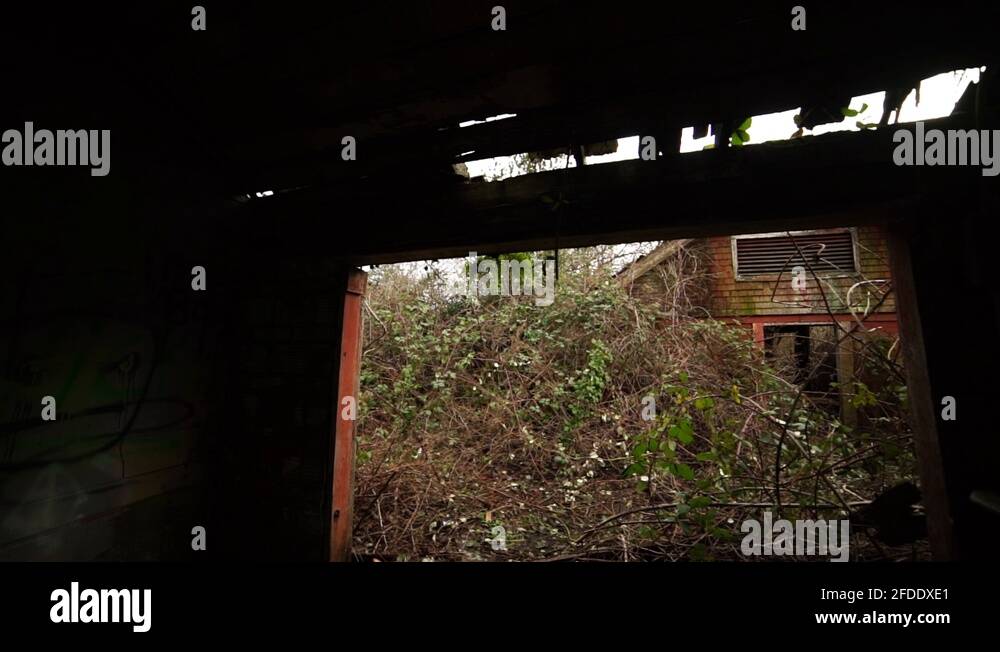 Slow pan from left to right of the dark and gloomy interior of an Stock ...