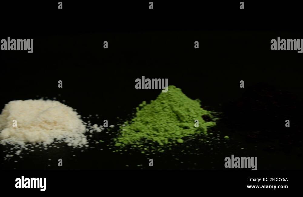 Nuts and seed powders on a black background Stock Video Footage - Alamy