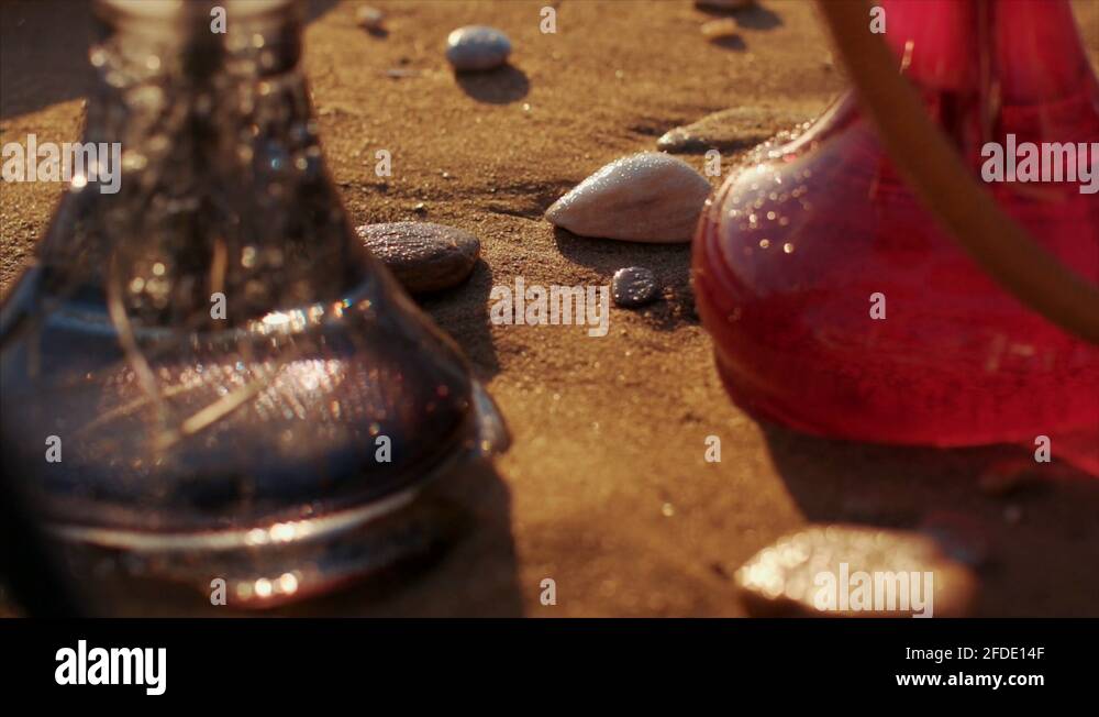 hookah at the seaside. Sea wave hitting the hookah bottle. smoke the ...
