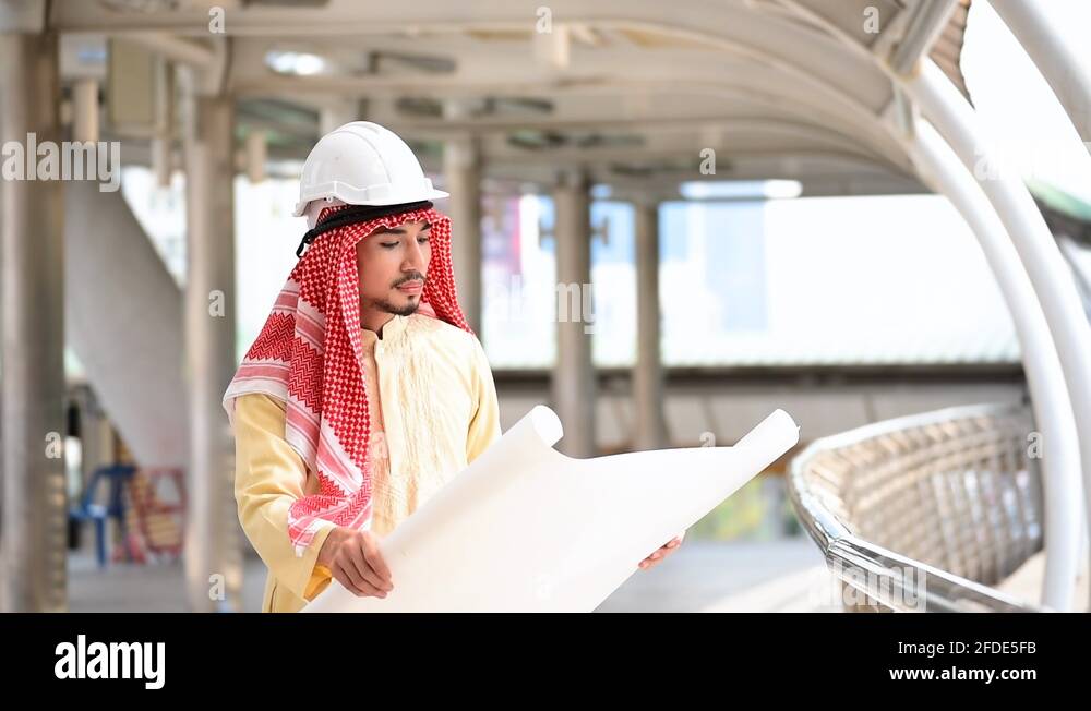 Arab civil engineer construction project hold blueprint, pointing at ...