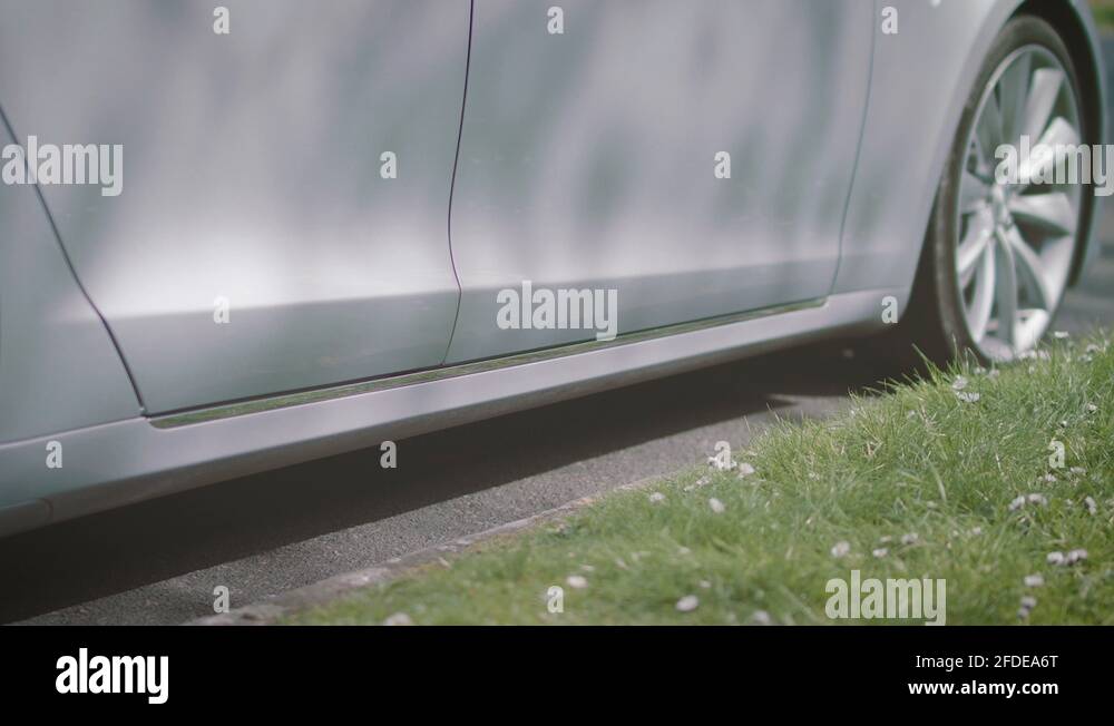 Tesla Model S door opening low angle as driver steps out Stock Video ...