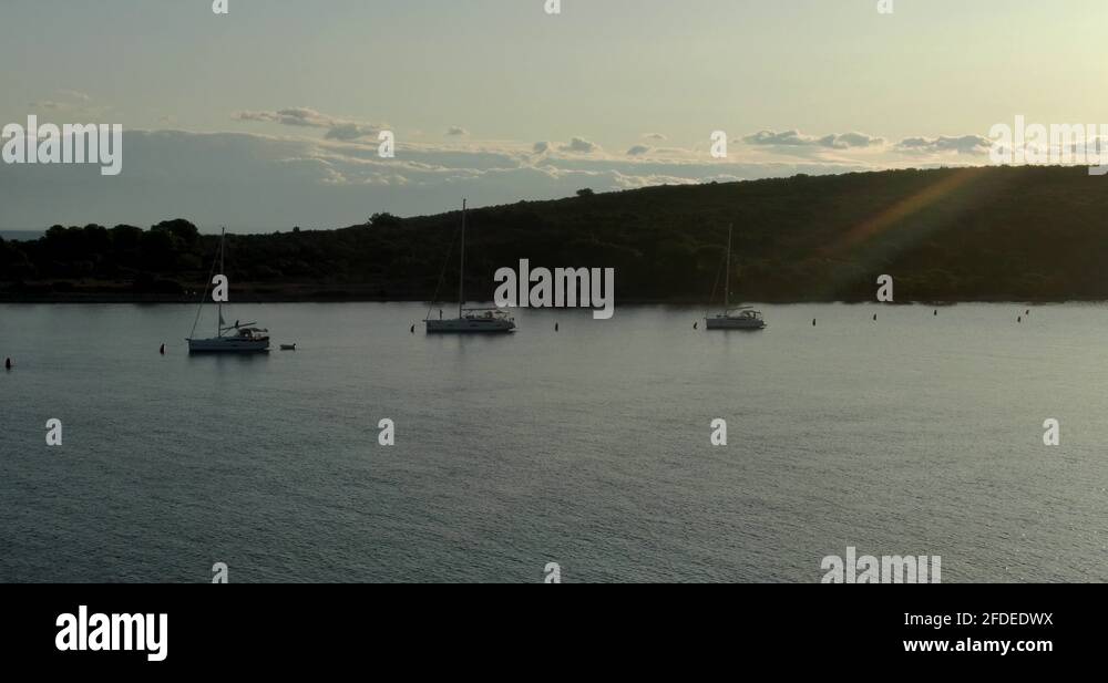 A video of a bunch of anchored sail boats in between the two islands ...