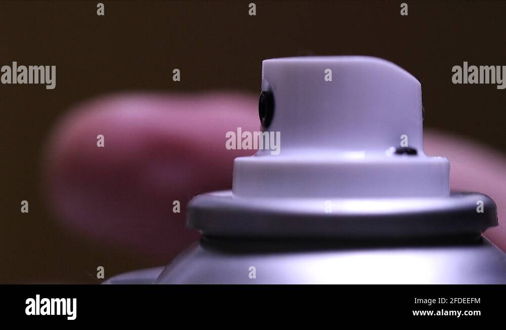 Grabing a Spray can of silicone Spray, pressing the nozzle of the can ...