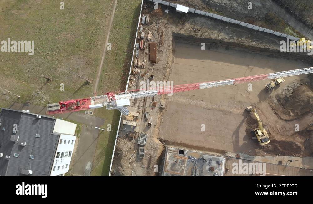 Drone fly over a tower crane with two excavator working in a ...
