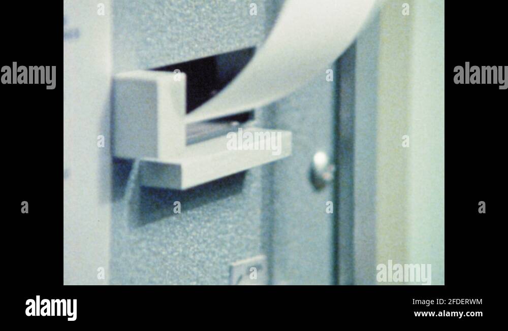 1970s: Receipt exits computer. Digital numbers change. Technician looks ...