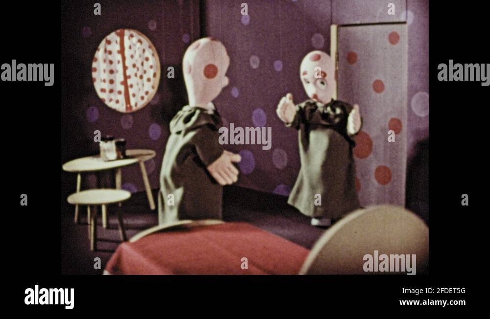 1960s: Two identical hand puppets have a conversation in room. Puppet ...
