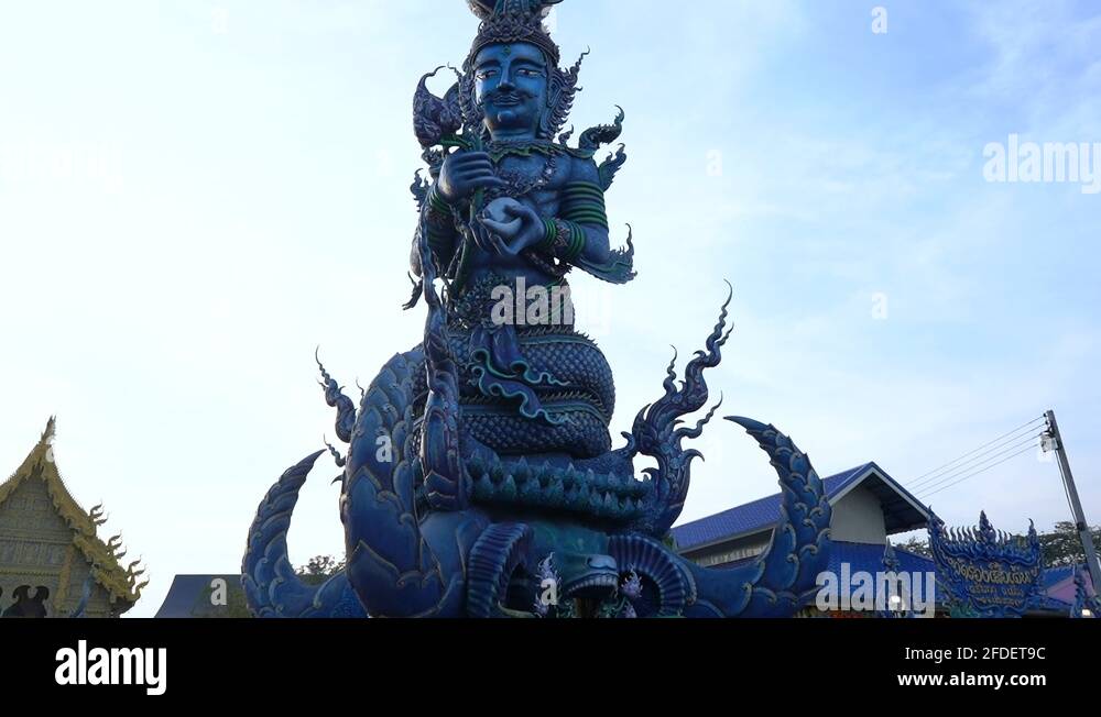 Pan + Tilt revelation of gate statue at Wat Rong Sear Tean (Blue Temple ...