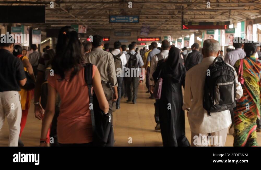 crowd of pedestrian commuters crossing the foot over railway bridge on ...
