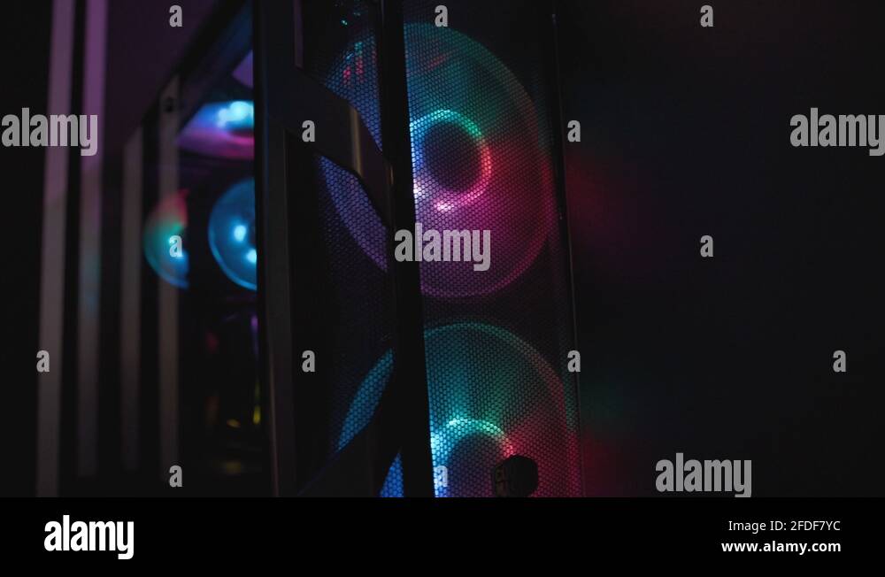 Rotating computer fans lit by LED light, inside an open computer case ...
