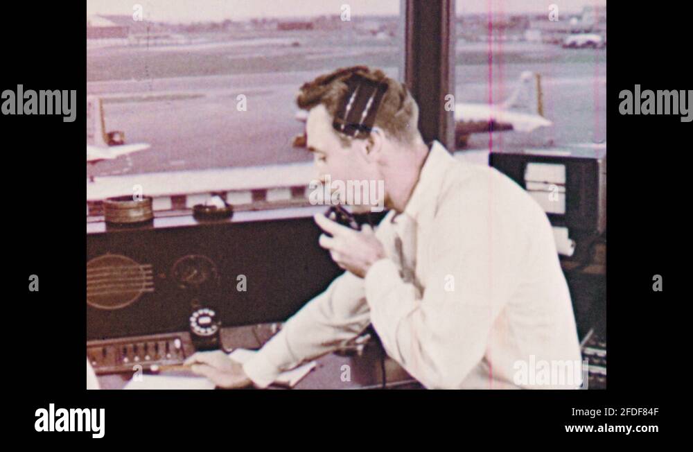 1960s: Ground control officer speaks into radio. Plane taxis toward ...