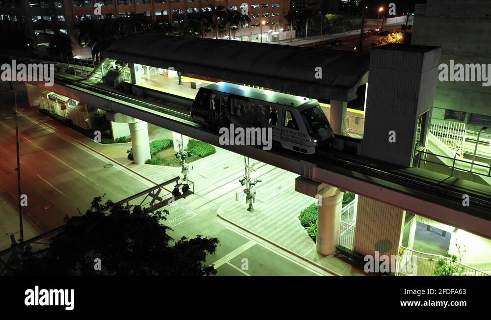 Tram departing from elevated platform station Downtown Miami Metrorail ...