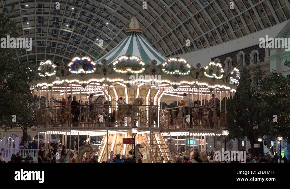 People on spinning carousel at Dream island amusement park Stock Video ...
