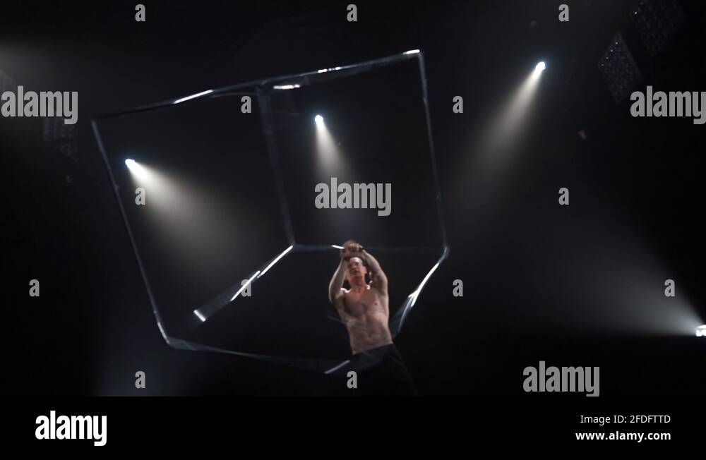 circus male muscular performer making tricks with juggling cube props ...
