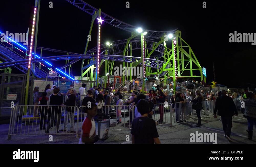 Pan of a Pinfari RC-48 Rollercoaster at The Florida State Fair at Night ...