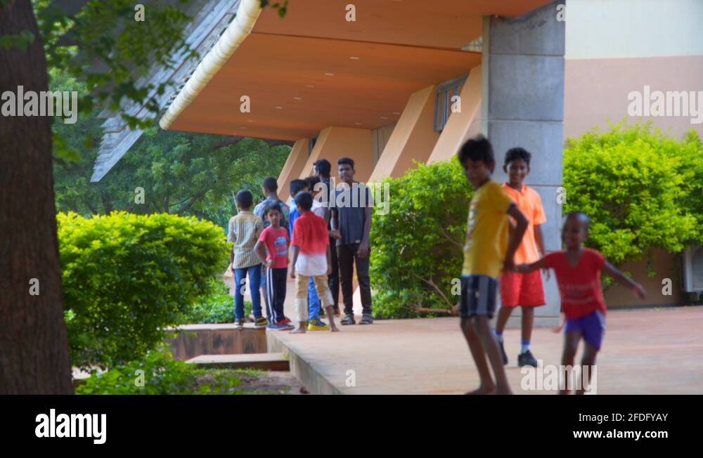 Indian children play around Town Hall building, Auroville cityscape ...