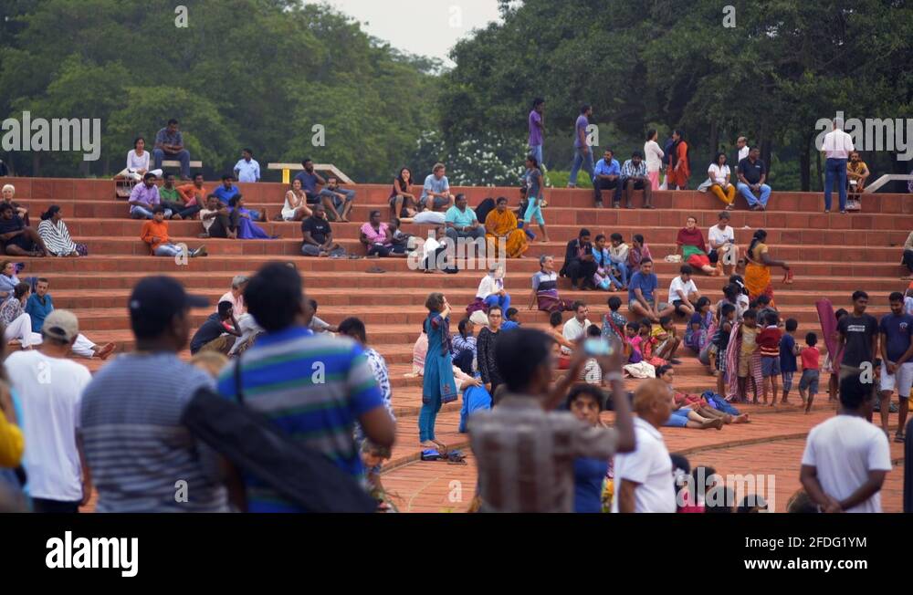 Many people at Matrimandir temple of the Mother amphitheater, Auroville ...