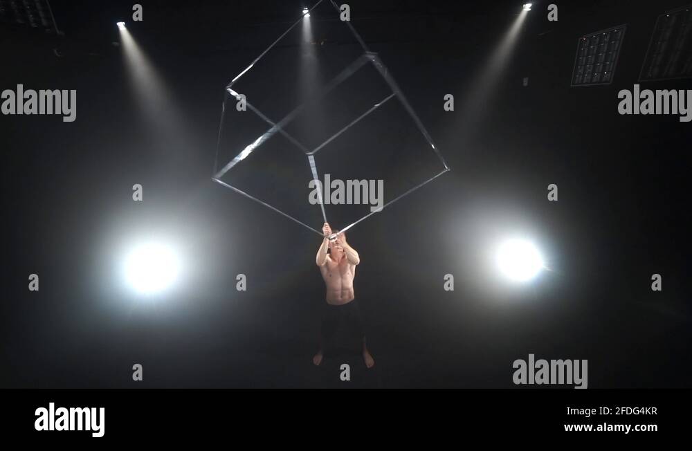 circus male muscular performer making tricks with juggling cube props ...
