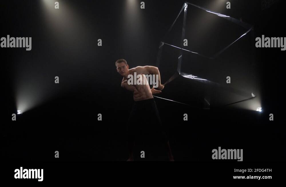 circus male muscular performer making tricks with juggling cube props ...