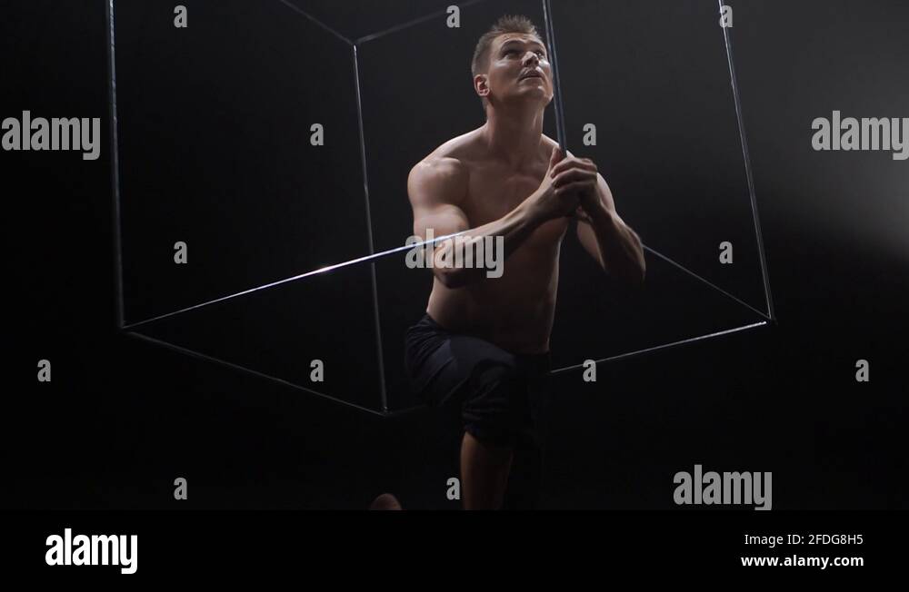 circus male muscular performer making tricks with juggling cube props ...