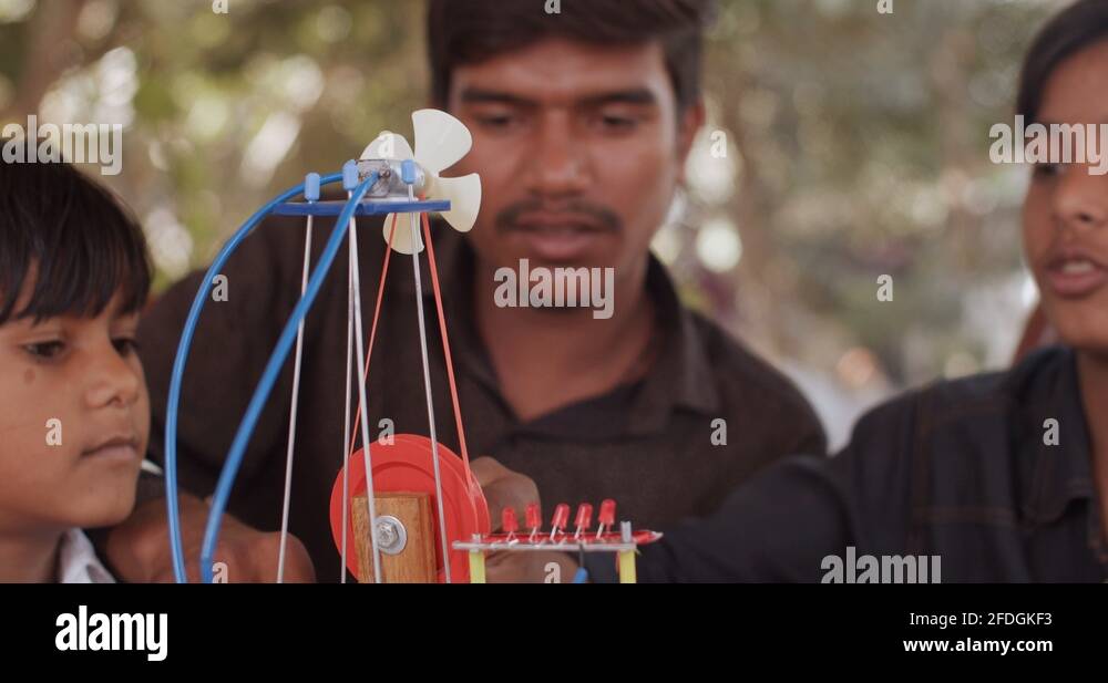 Group of Indian kids learning from practical experiments from teacher ...
