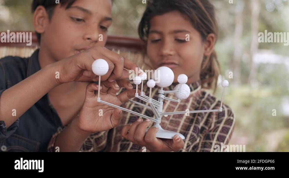 Group of Indian kids learning from practical experiments from teacher ...