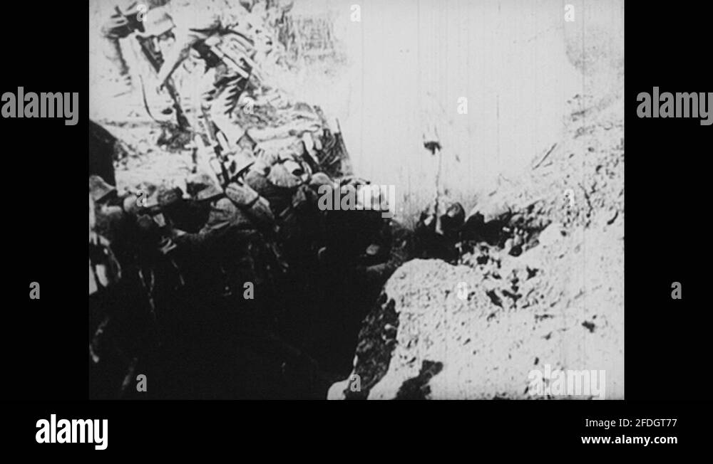 1910s: Soldiers climb out of trenches as ground explodes around them ...
