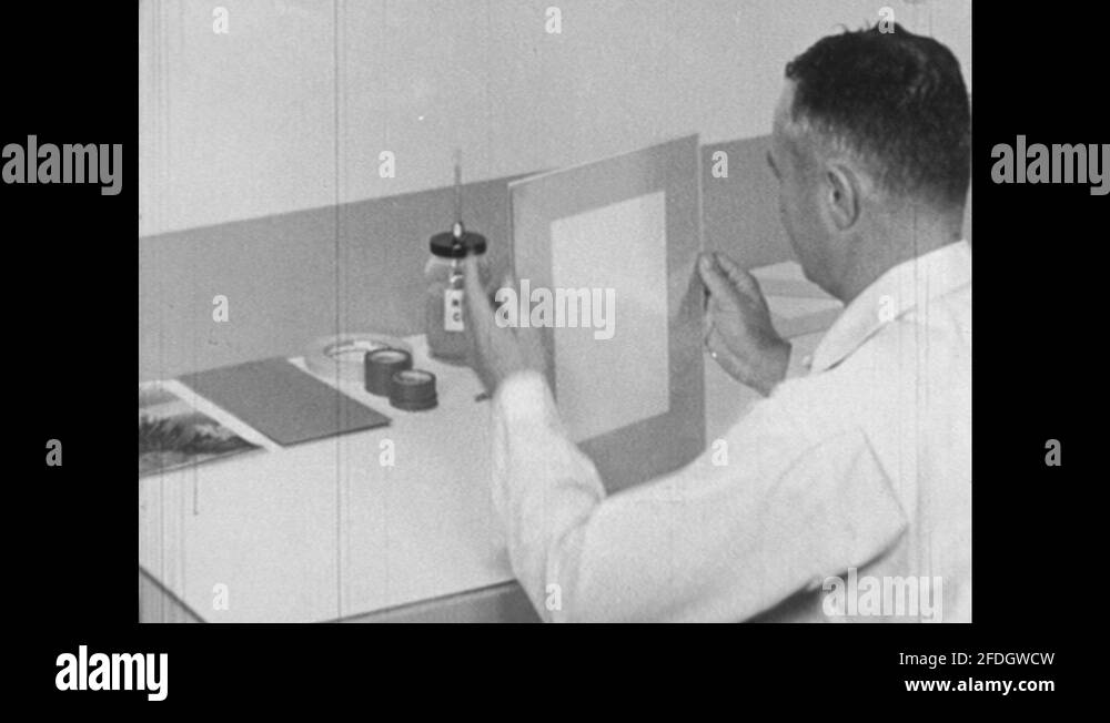 1960s: Man at drafting table takes piece of cardboard with glass frame ...