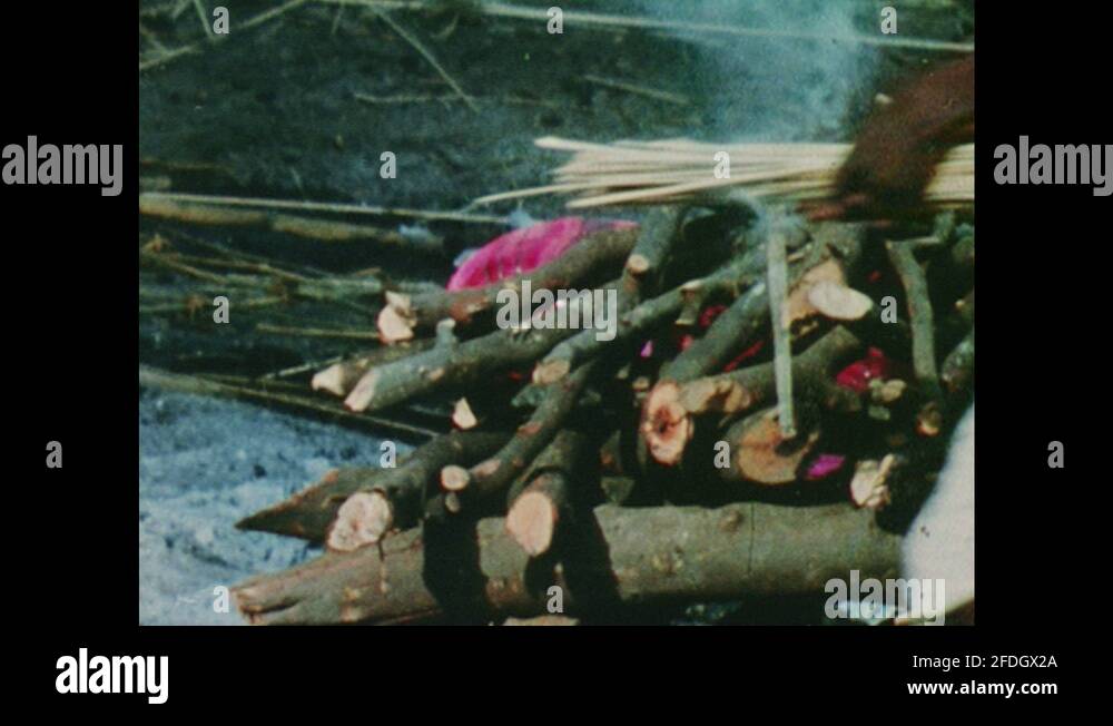 1960s: Man burns plant and walks around deceased on pyre. Man lights ...