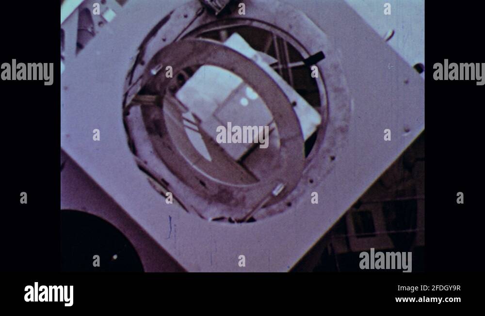 1960s: Telescope hatch opens. Teletype machine types out paper. Man ...