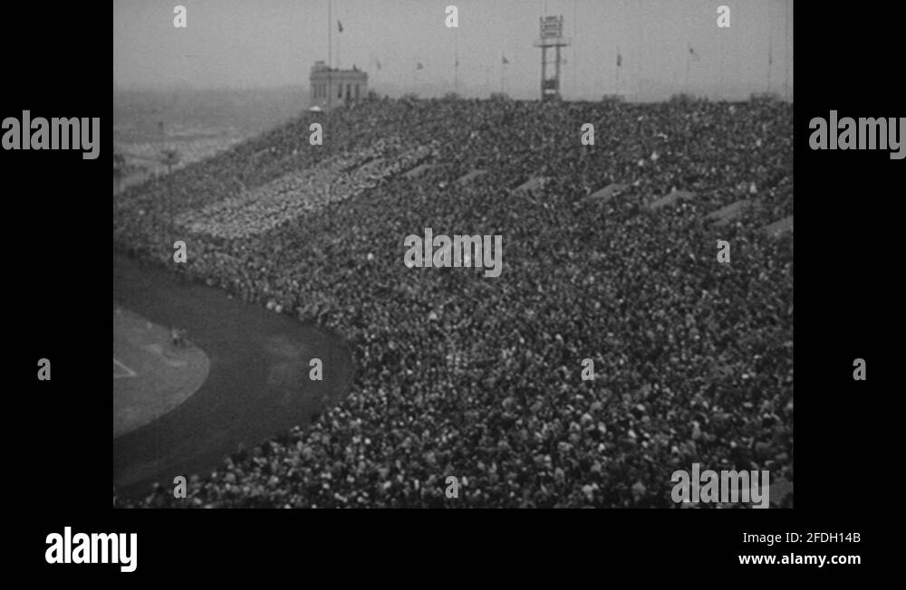 1940s: crowds of fans in stadium cheering, team fumbles for turnover ...