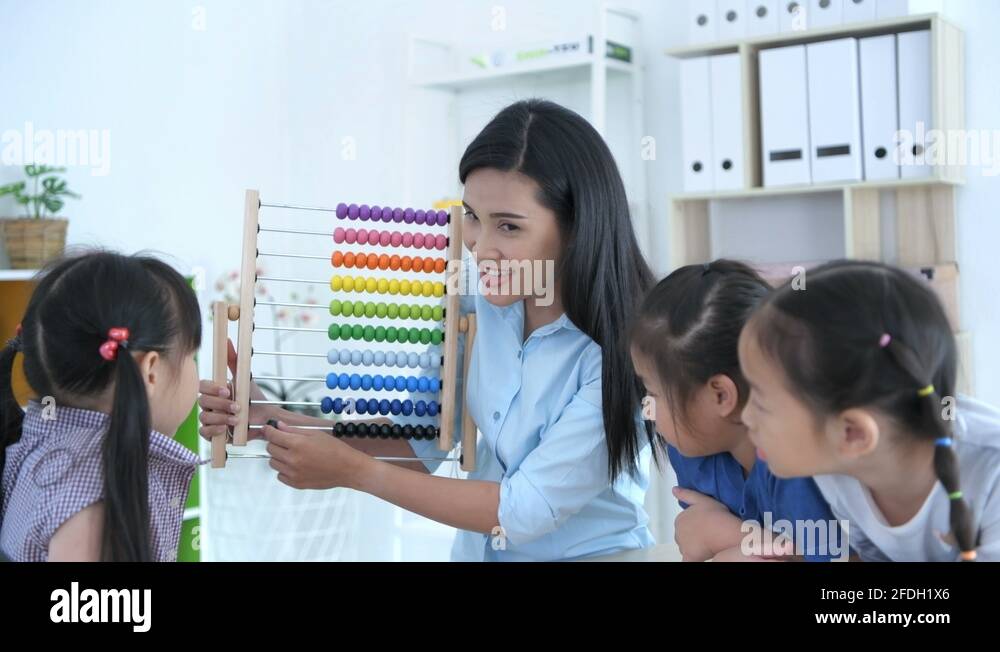 Educational concepts. The teacher is teaching math with abacus for ...