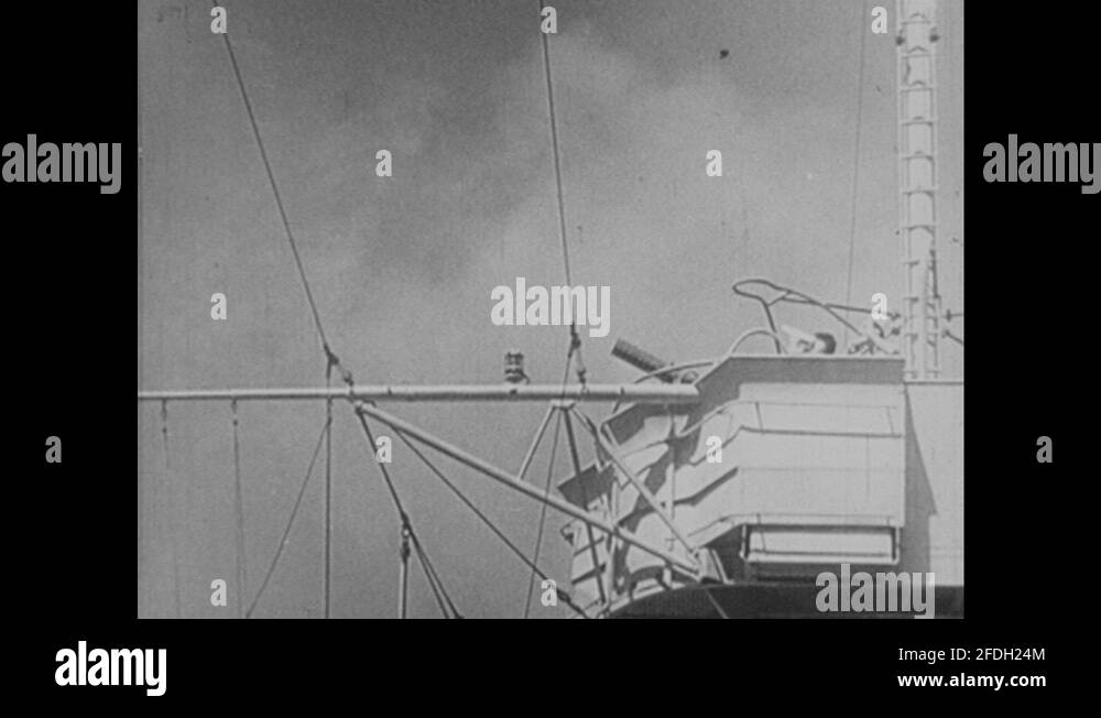 1940s: Cannons and guns fire on naval warships. Water splashes from ...
