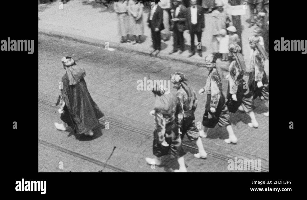 1920s: People walk in a parade. Band marches in field Stock Video ...