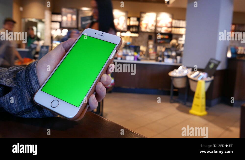 Hand holding green screen iphone inside Starbucks store with 4k ...