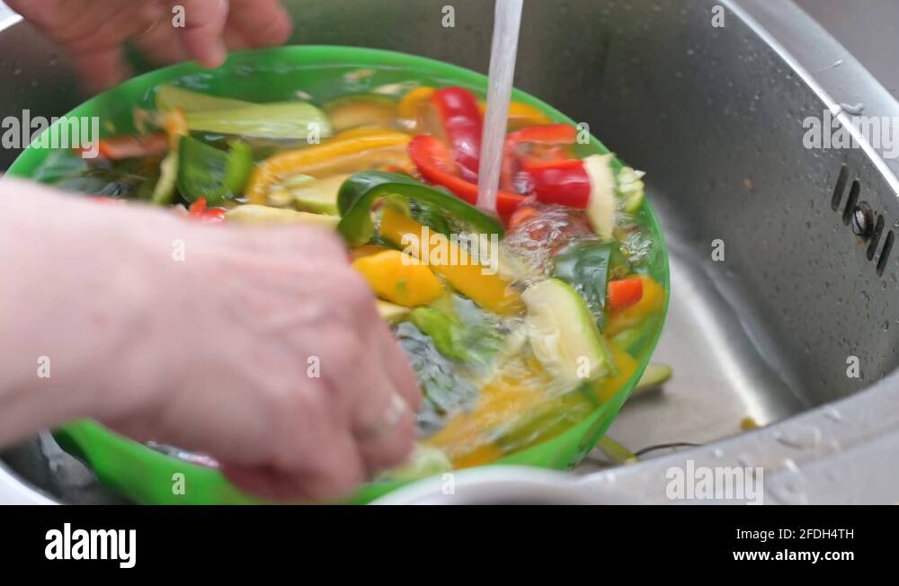 washing the vegetables in kitchen sink Stock Video Footage - Alamy