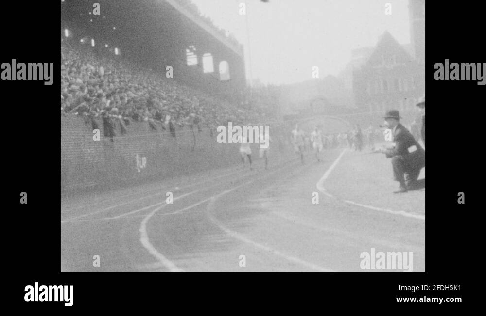 1920s: Full stadium, huge crowd, track and field competition, men run ...