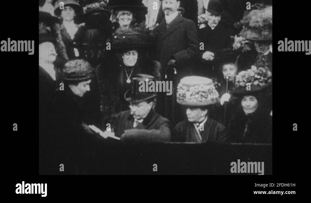 1920s: Teddy Roosevelt signs paper. Man stands and tips hat. Man and ...