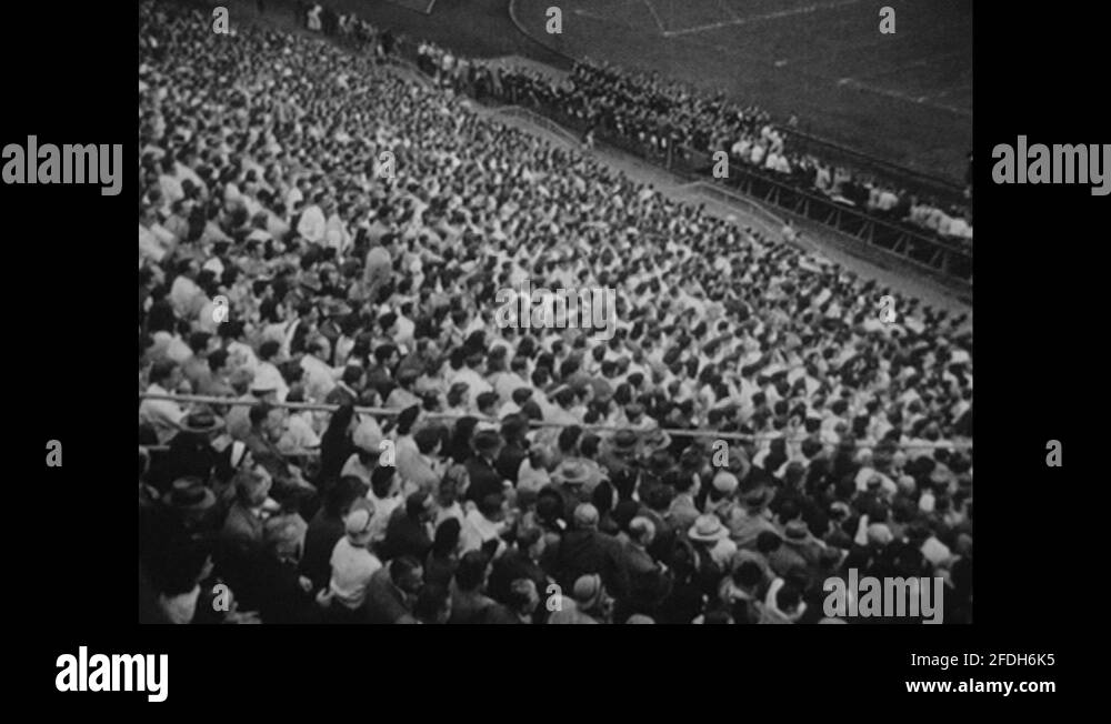 1940s: crowds of fans in stadium cheering, quarterback throws ...