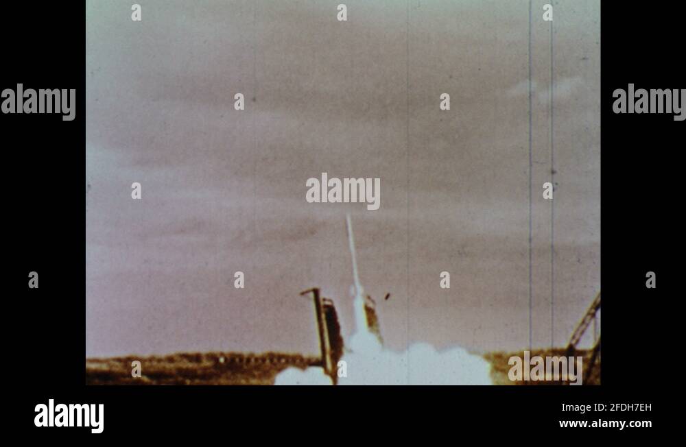 1960s: Rocket launches into sky. Launching into sky looking back down ...