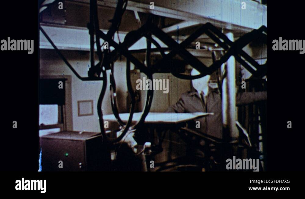 1960s: Interior of observatory. Man studies image of a sun in the ...