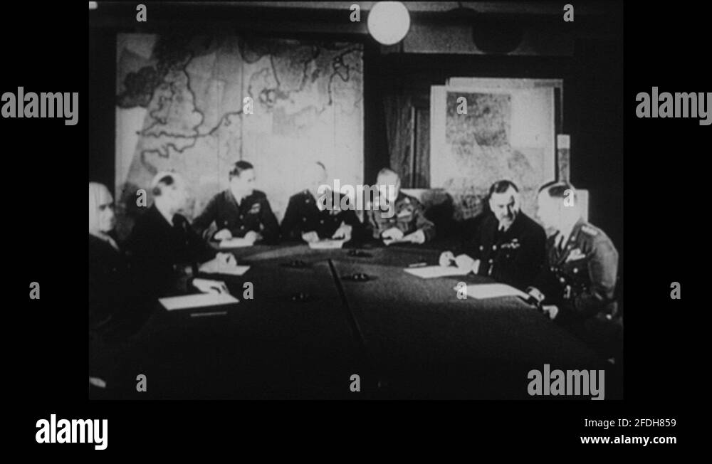 1940s: Generals sit around table in war room. Officer speaks to general ...