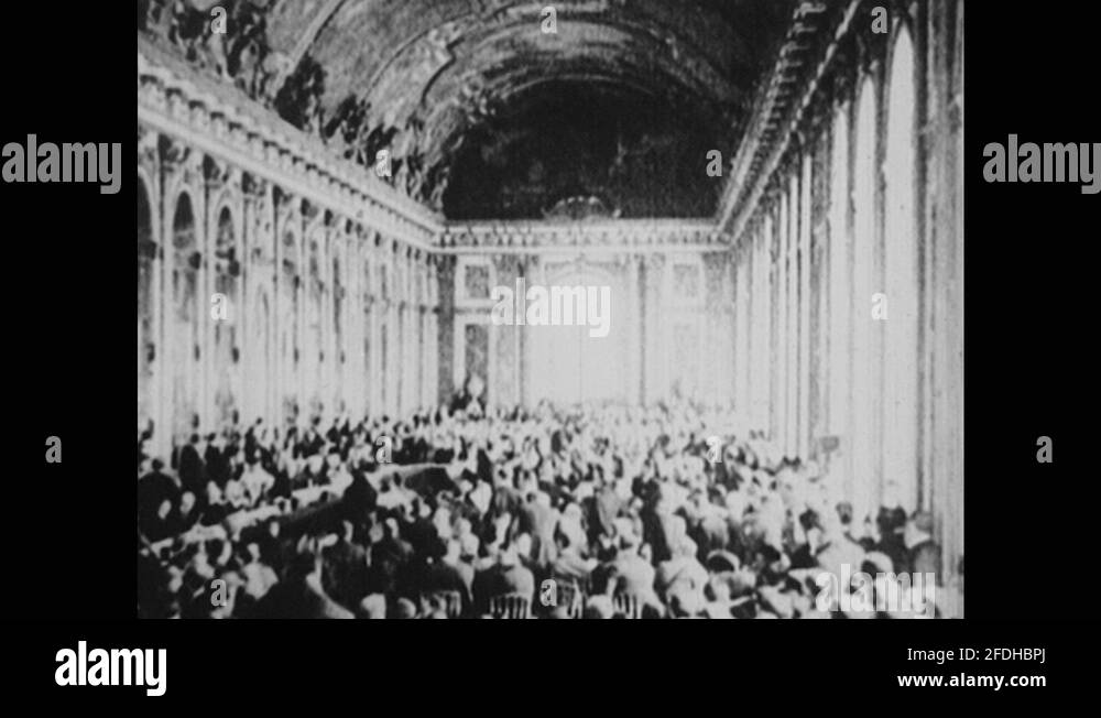 1910s: Crowd of people in large hall. People are seated in large hall ...