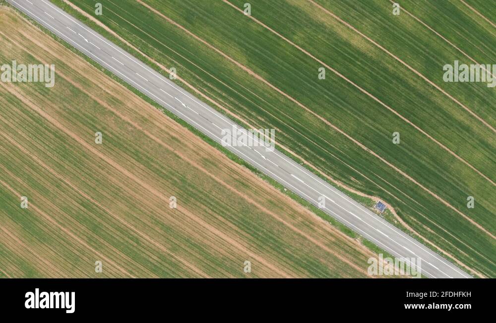 green grass texture background fields aerial top shot with a road ...