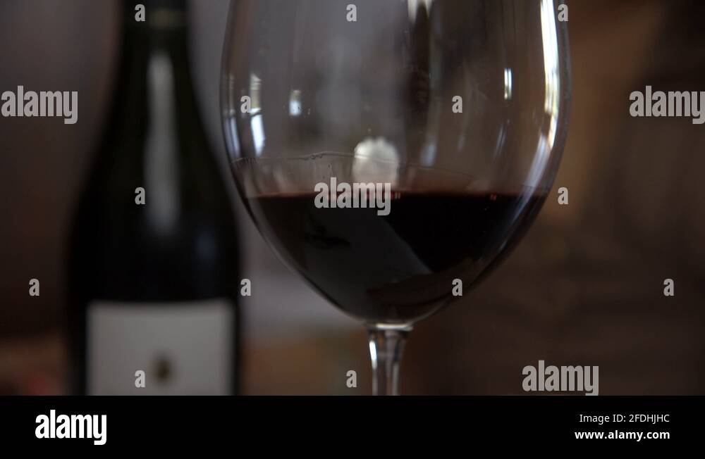 Passito red wine showing the viscosity after a swirl in slow motion 4k ...