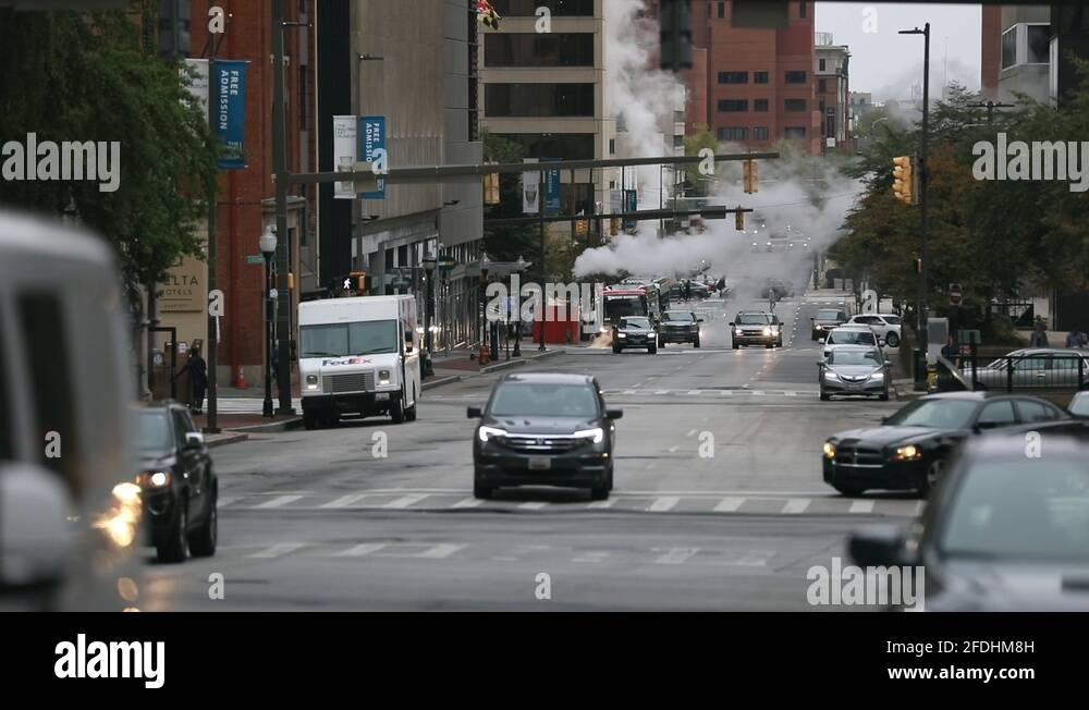 Traffic in Baltimore City Street and Steam Pipes in Background ...